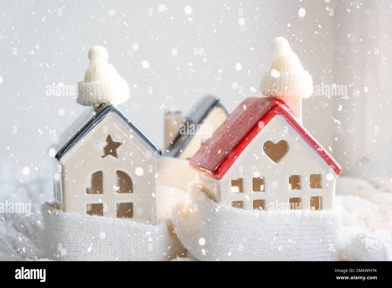 Cozy house is wrapped in a hat and scarf in a snowstorm -window sill ...