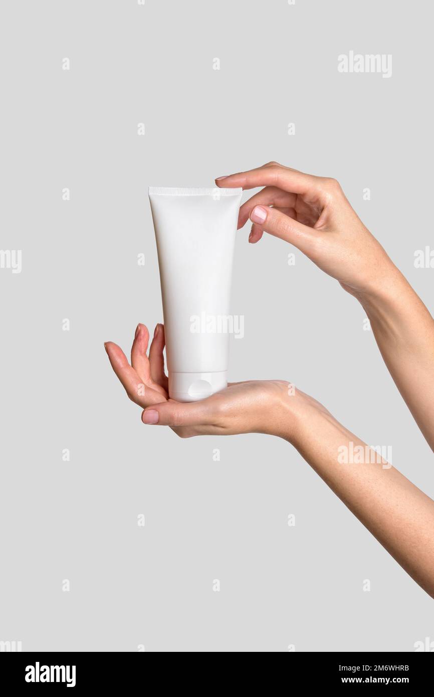 Woman hand showing cream product. Cosmetic product branding mockup ...