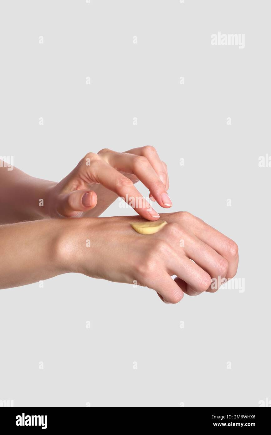Woman applying lotion to hand. Daily skincare and body care routine ...
