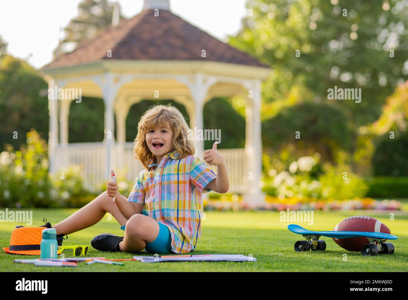School kid drawing in summer park, painting art. Little painter draw ...