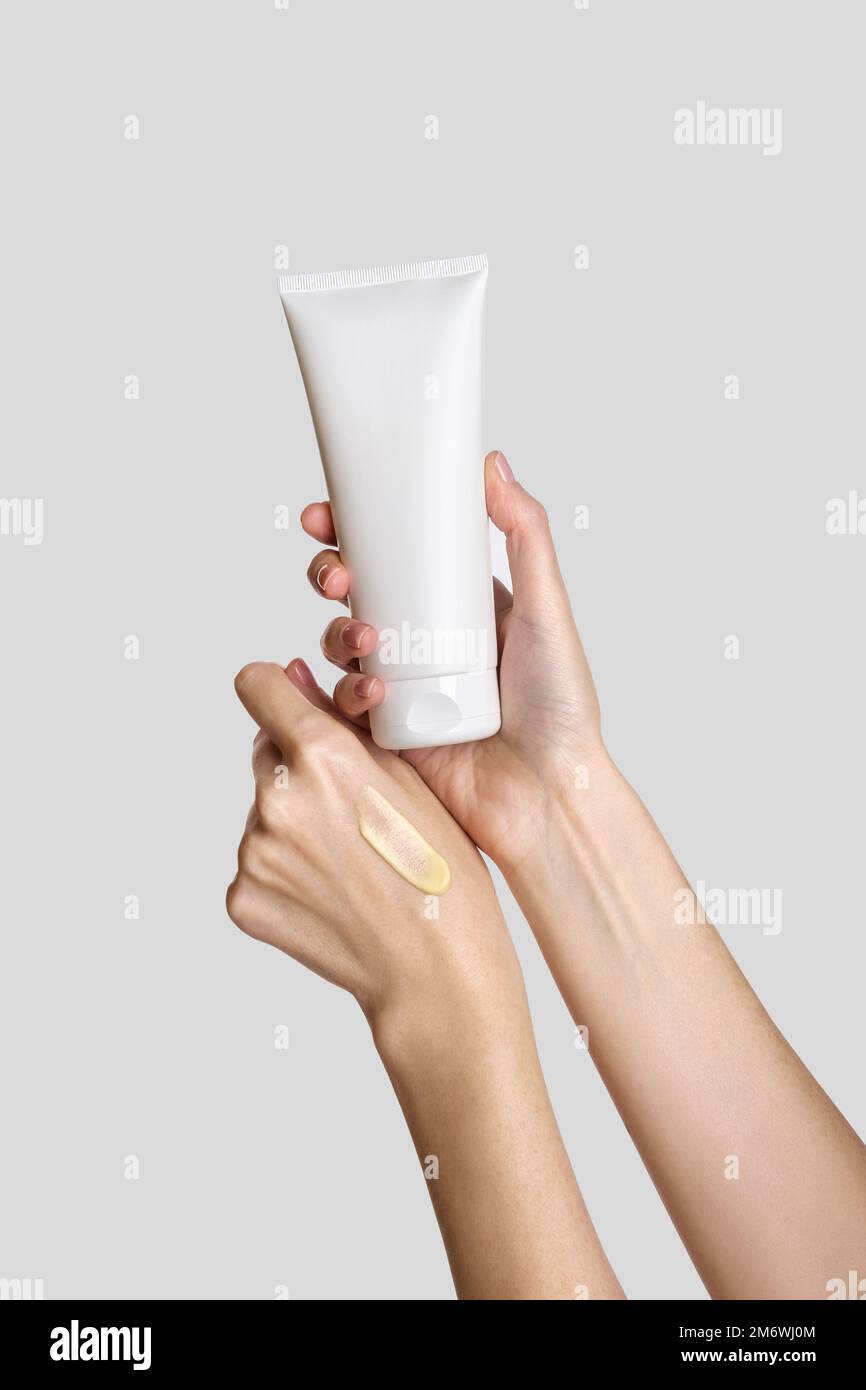 Woman hand showing cream product. Cosmetic product branding mockup ...