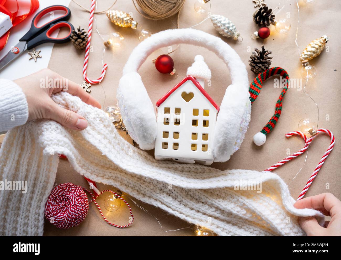 Cozy house in Christmas decor layout, warm knitted scarf, hat ...