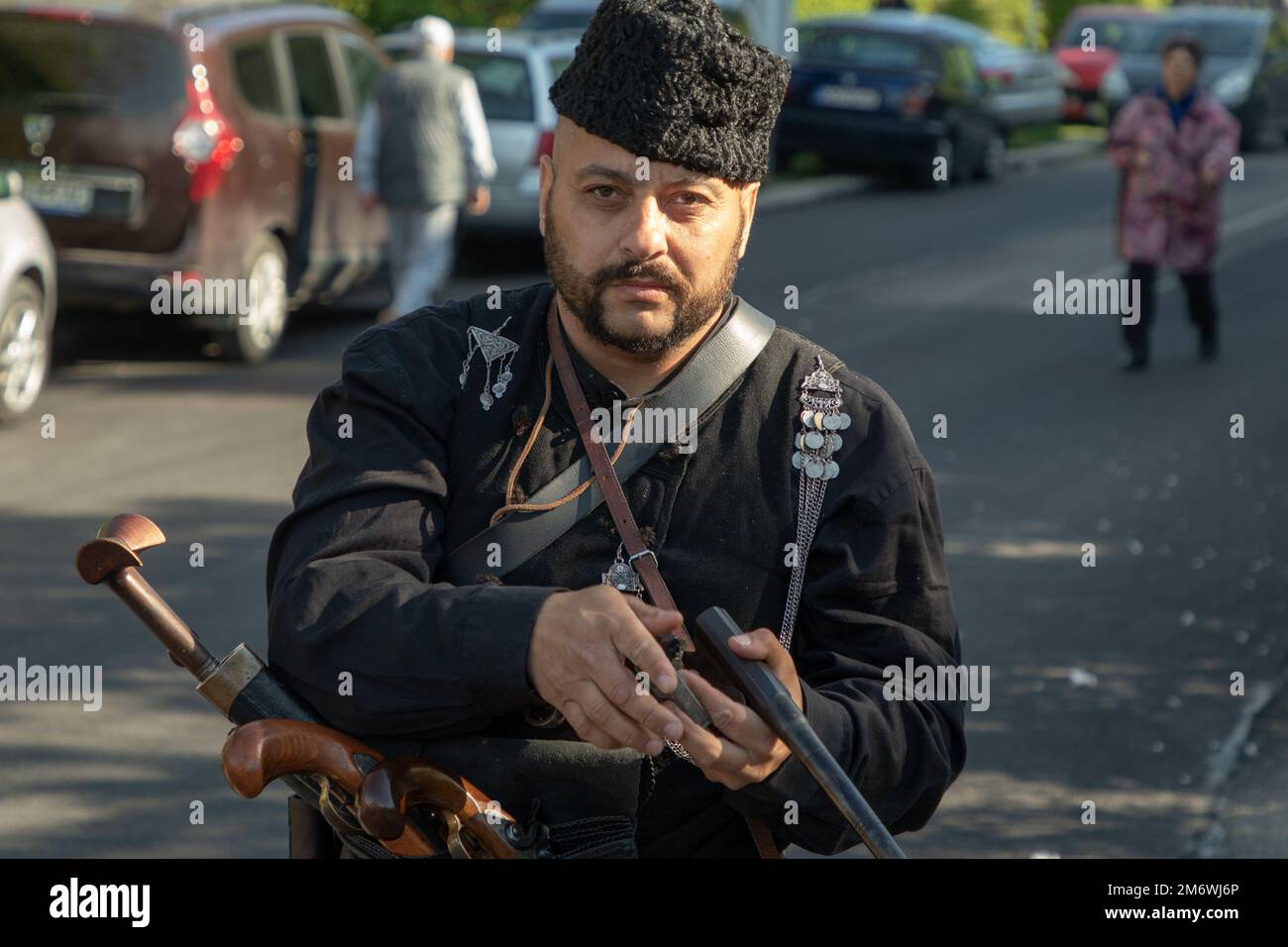 A Bulgarian local dresses as Hadzhi Dimitar while reloading his prop ...