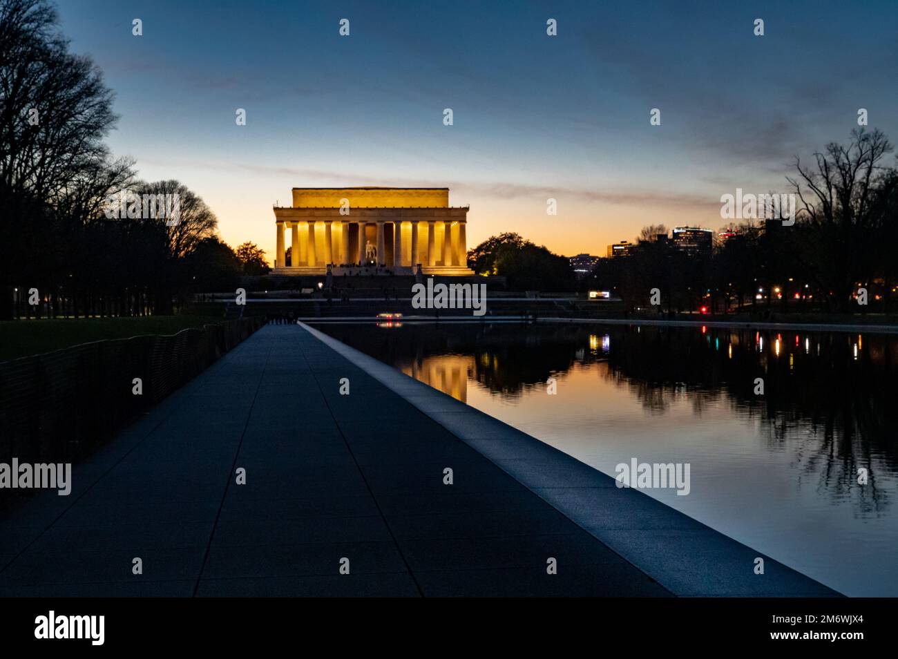 Sunset view with water reflection of the Lincoln Memorial, the monument ...