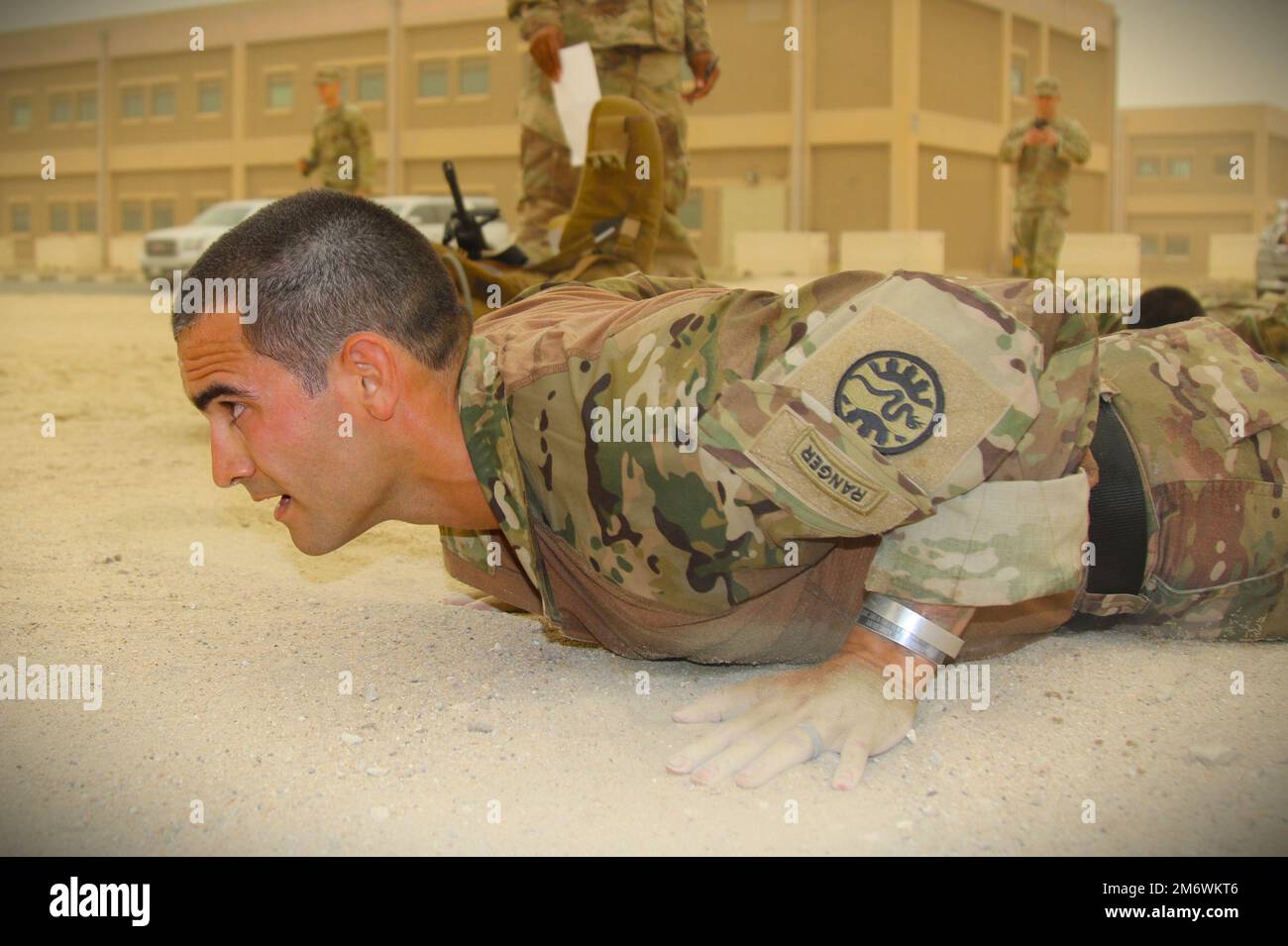 A Task Force Spartan Soldier performs hand release push-ups as part of ...