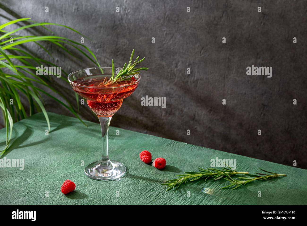 Summer refreshing alcoholic cocktail. Raspberry lemonade garnished with ...