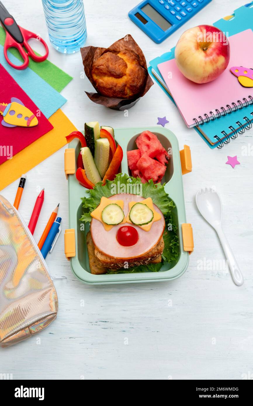 School lunch box for kids with food in the form of funny faces. School ...
