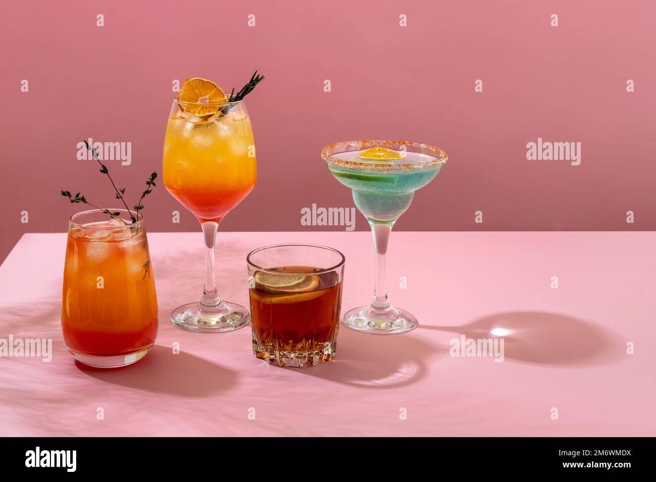 Colorful tropical cocktails. Refreshing colorful summer drinks on pink ...