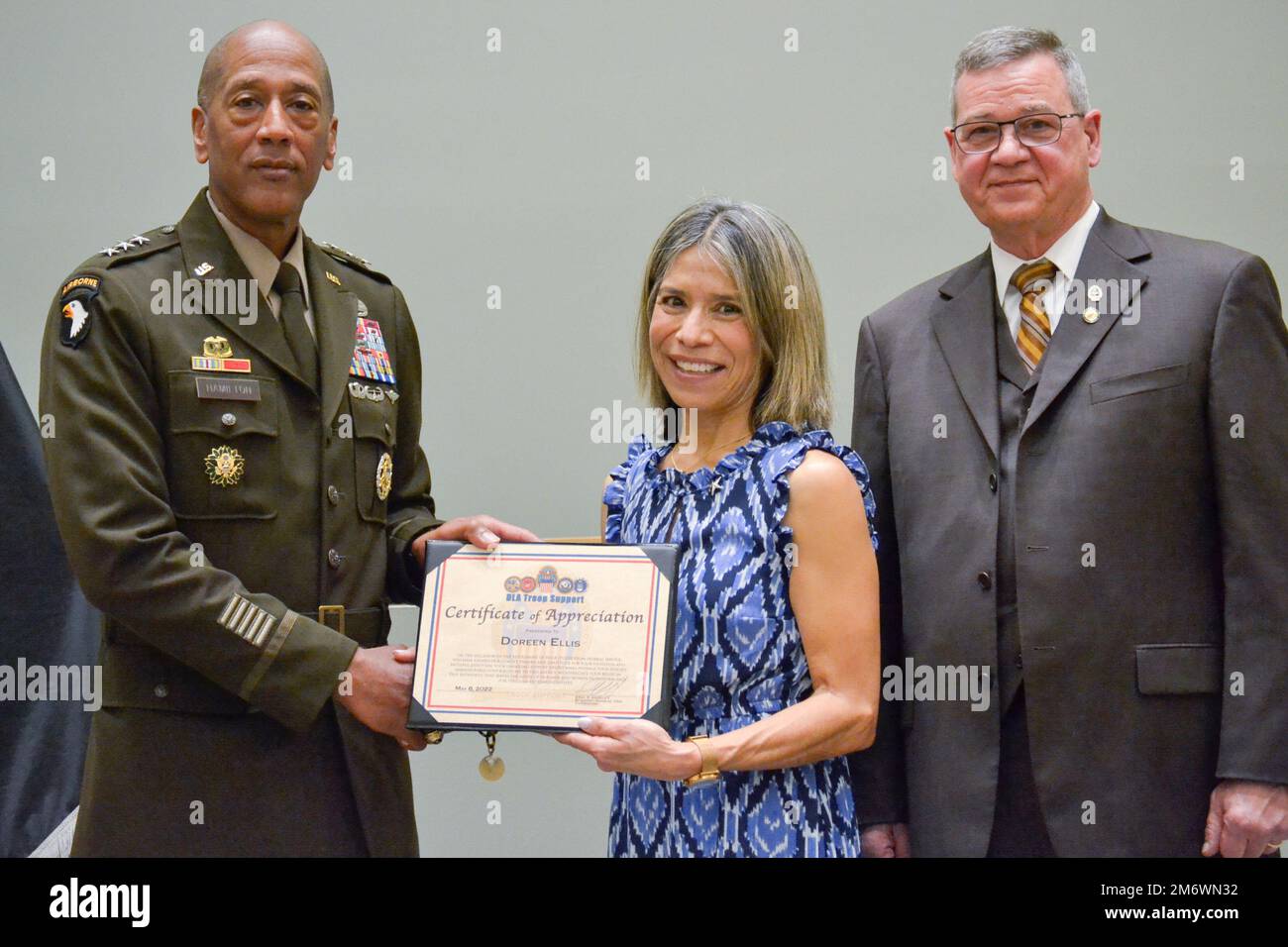 Doreen Ellis, center, receives a commander’s certificate of ...