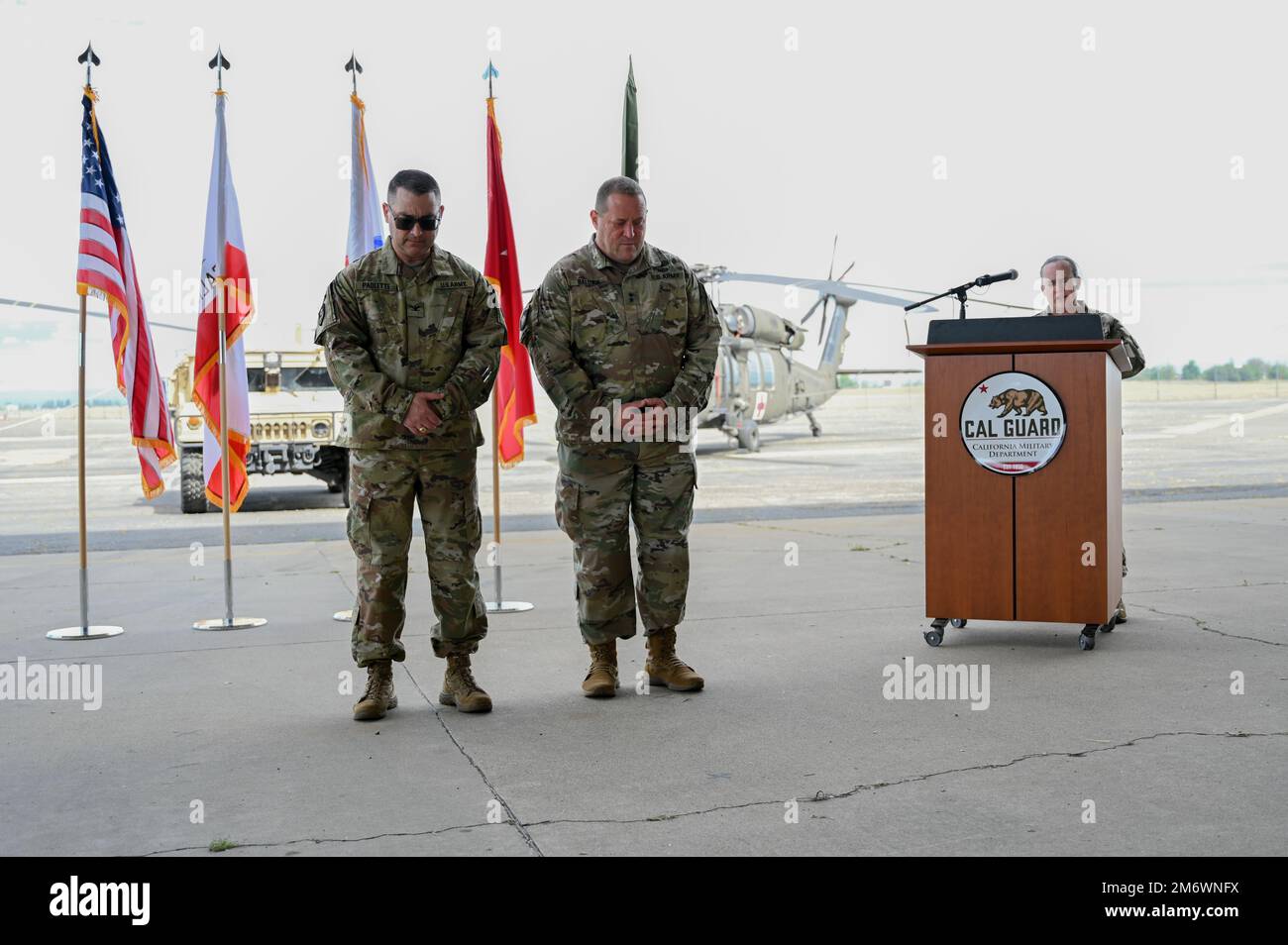 U.S. Army Col. Robert Paoletti and Maj. Gen. David Baldwin bow their ...