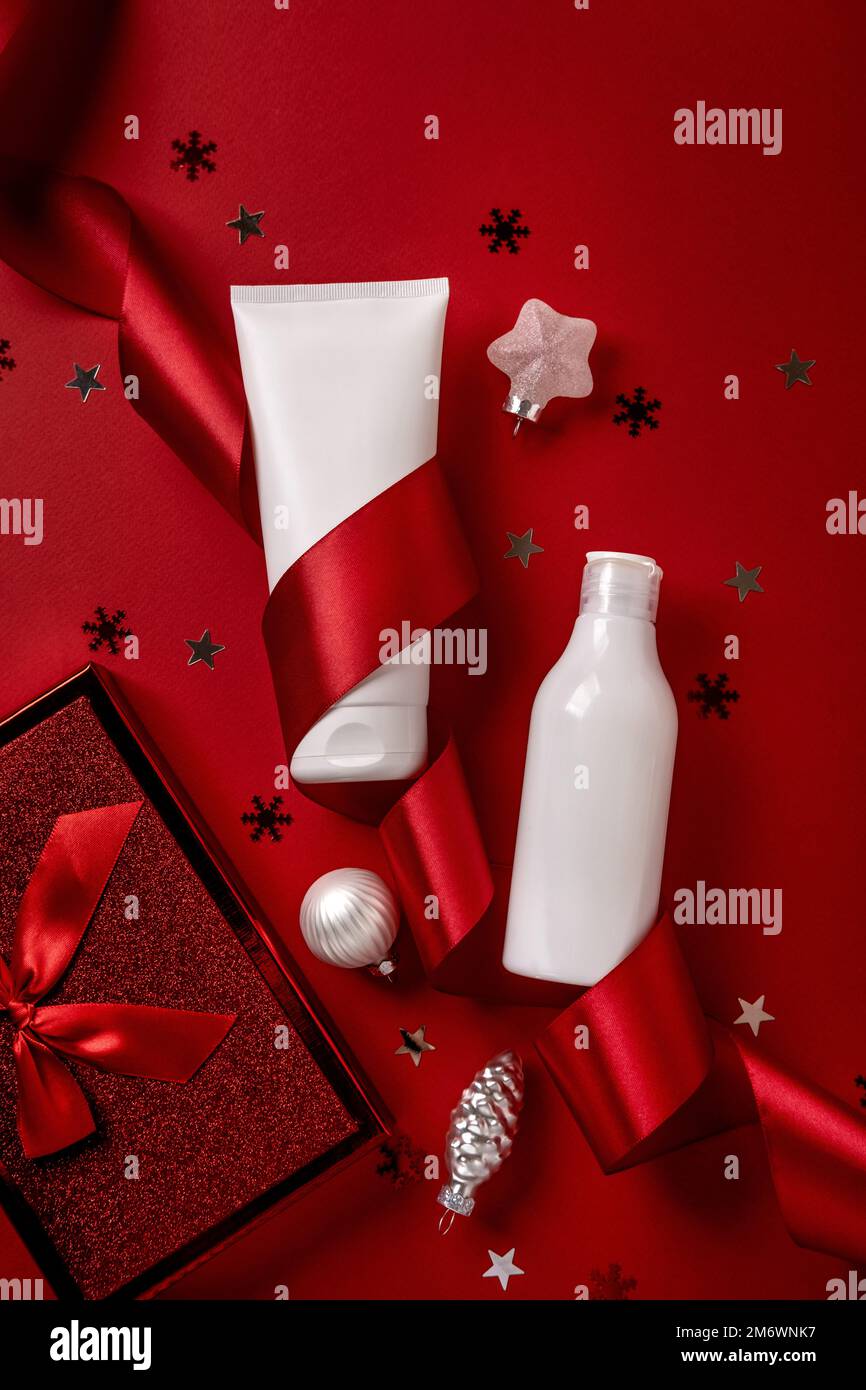 White bottles cosmetic products with red ribbon and Christmas ...
