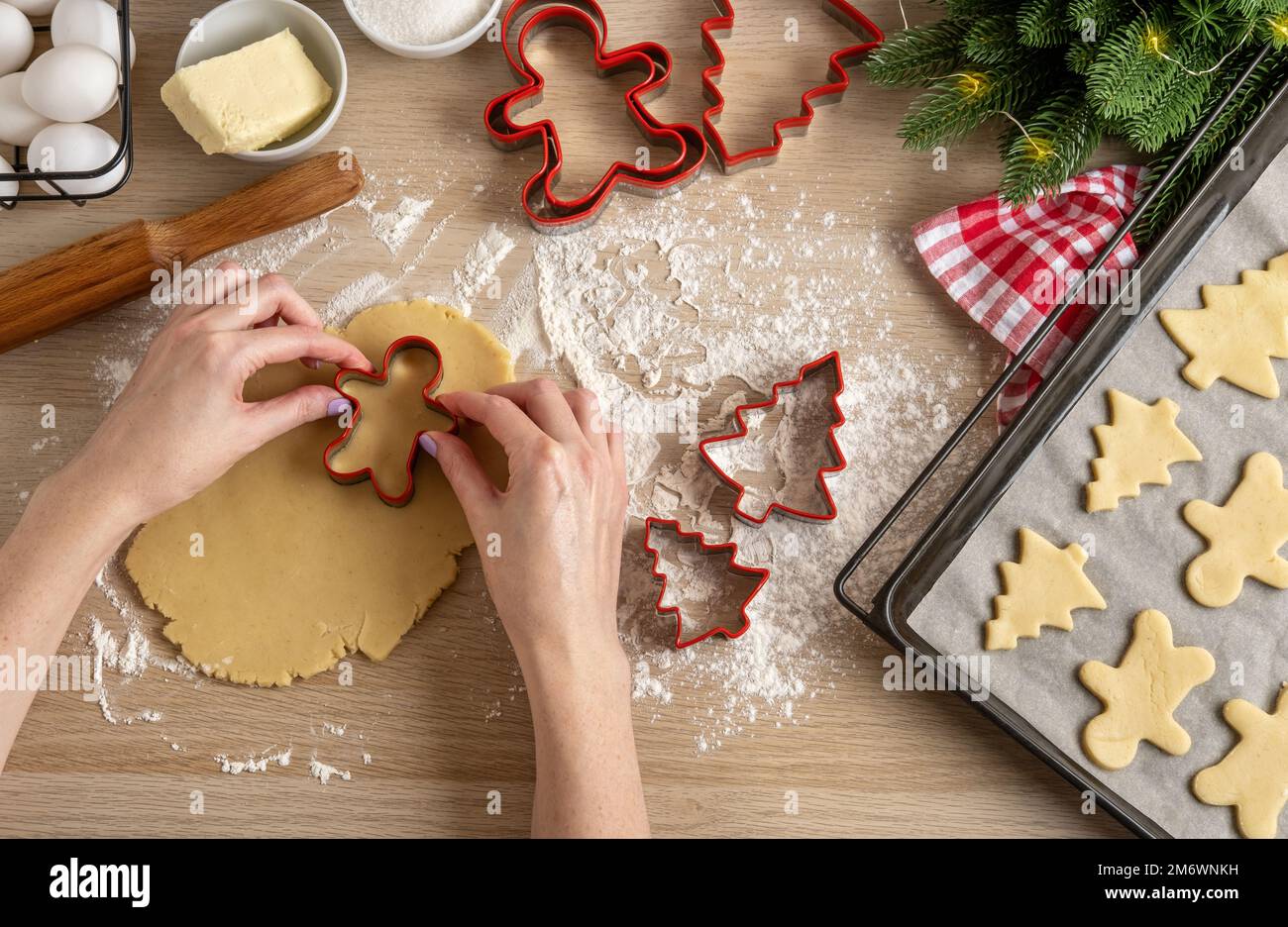 Woman Cutting Christmas gingerbread cookies. Making Christmas Cookies ...