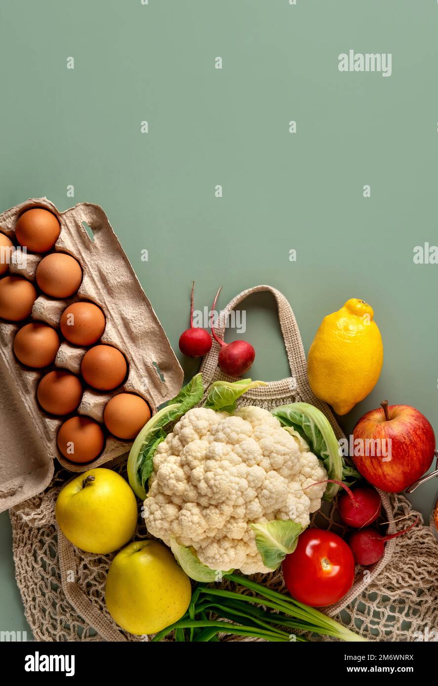 Zero waste shopping concept on green background. Fresh vegetables and ...