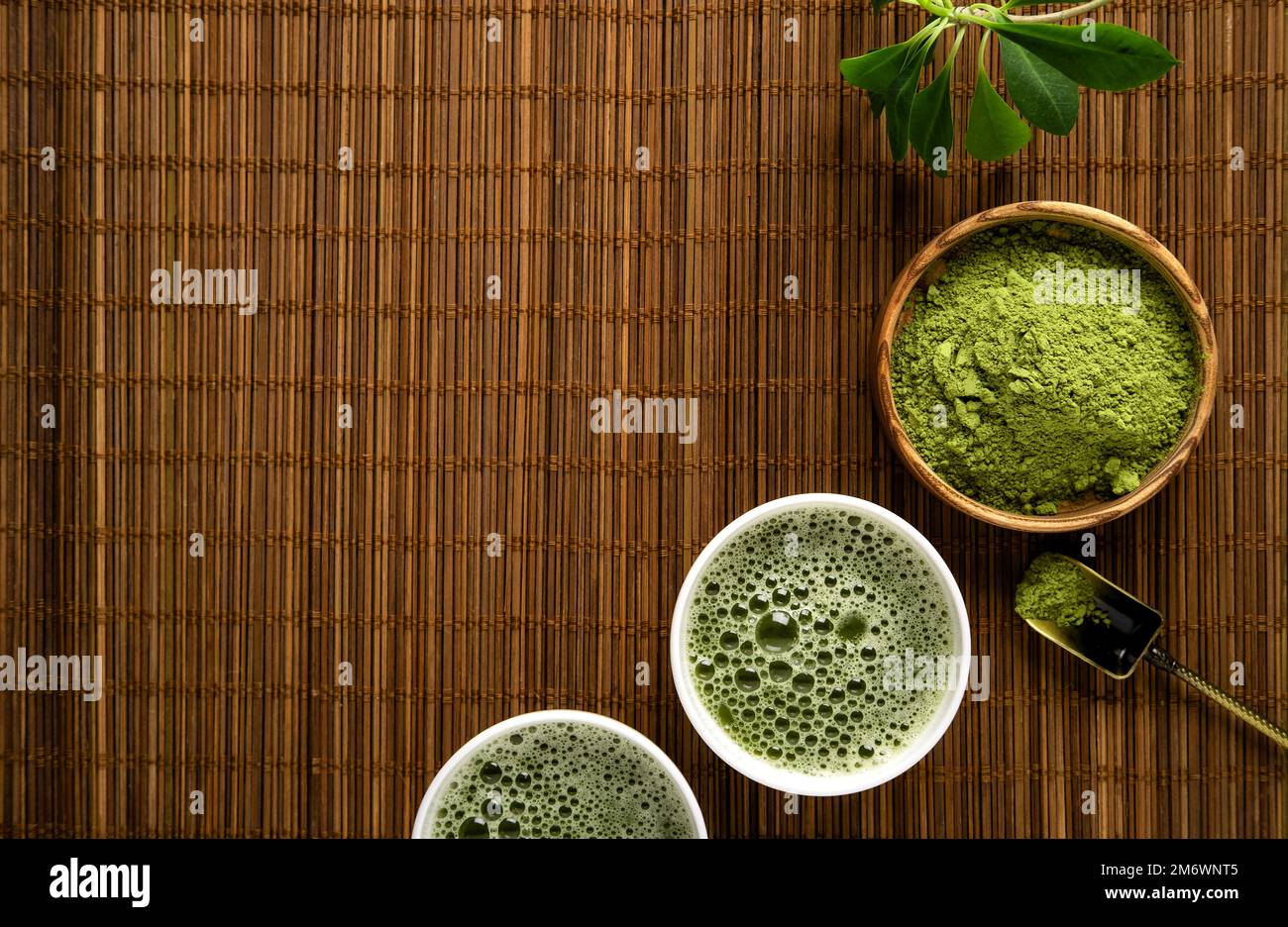 Matcha tea powder and tea accessories on bamboo napkin background. Tea ...