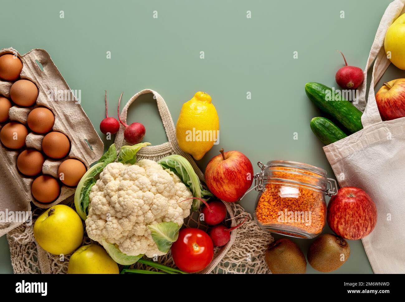 Zero waste shopping concept on green background. Fresh vegetables and ...