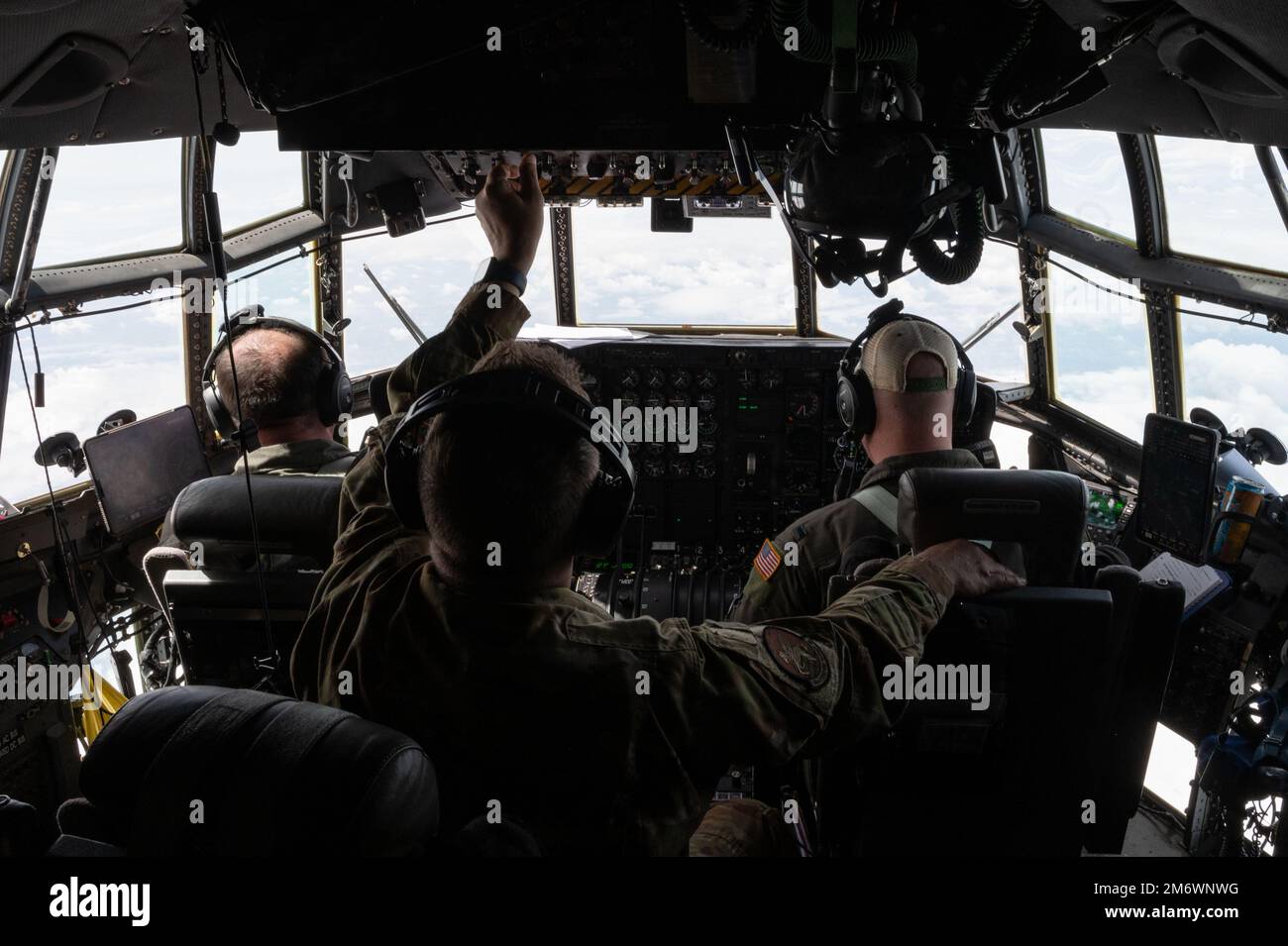 Air Force Master Sgt. Danny Purcell (center), a flight engineer with ...