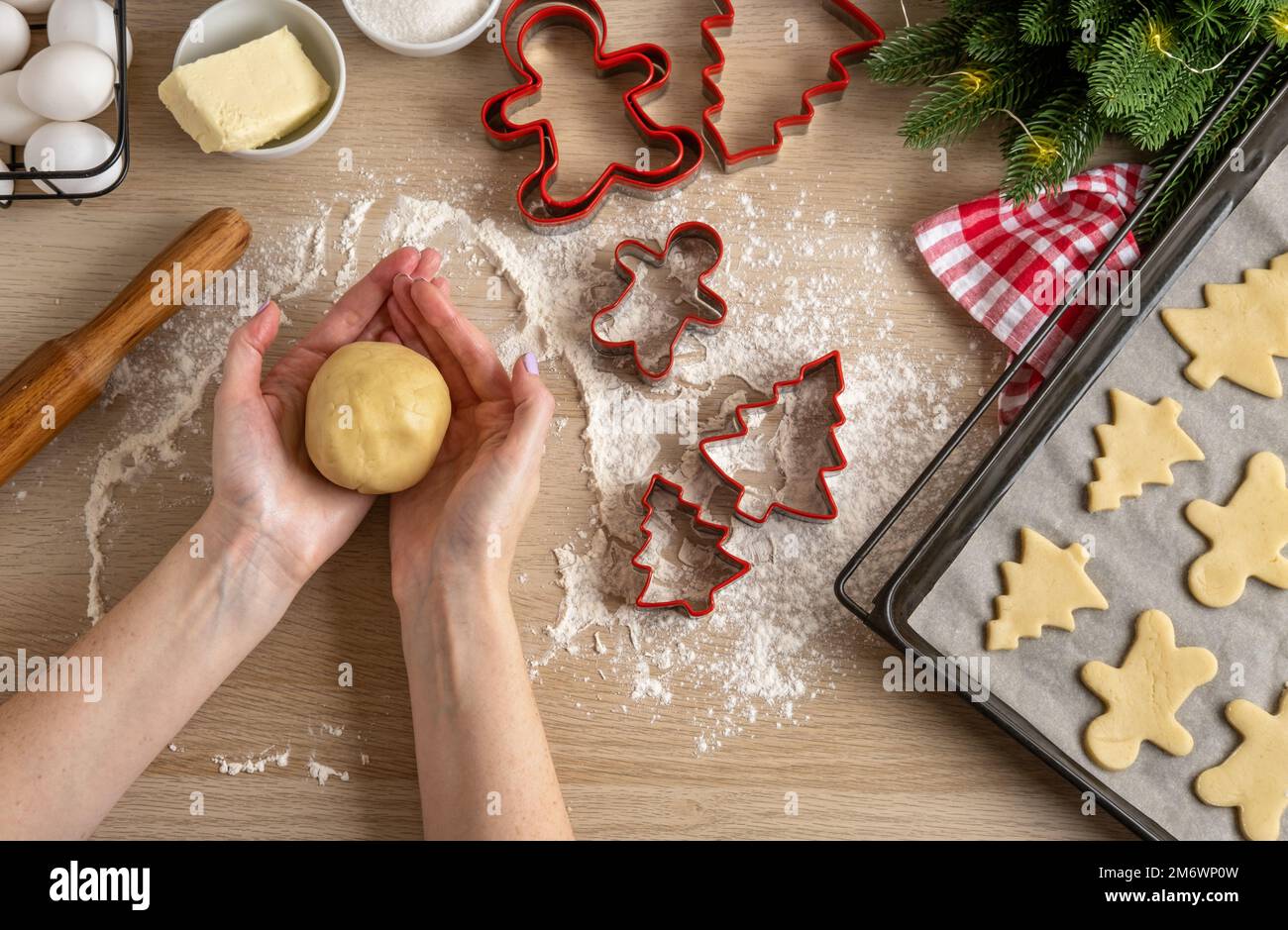 Female hands hold cookie dough. Making Christmas Cookies with ...