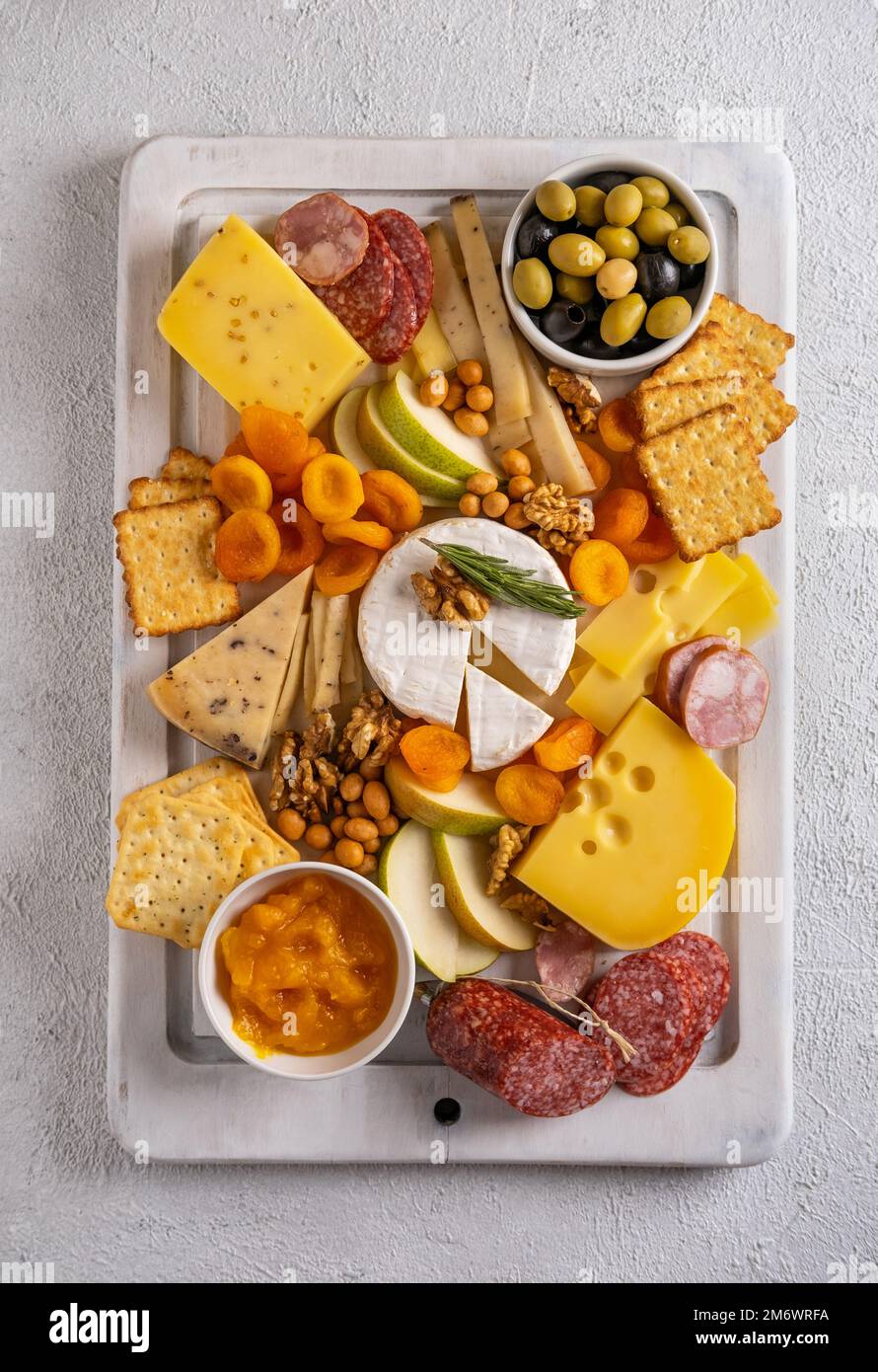 Different types of cheeses and cold cut meats. Top view on a white ... Different types of cheeses and cold cut meats. Top view on a white ...