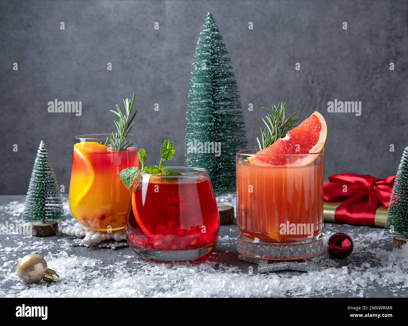 Three festive cocktails with various citrus. Assortment of alcohol ...