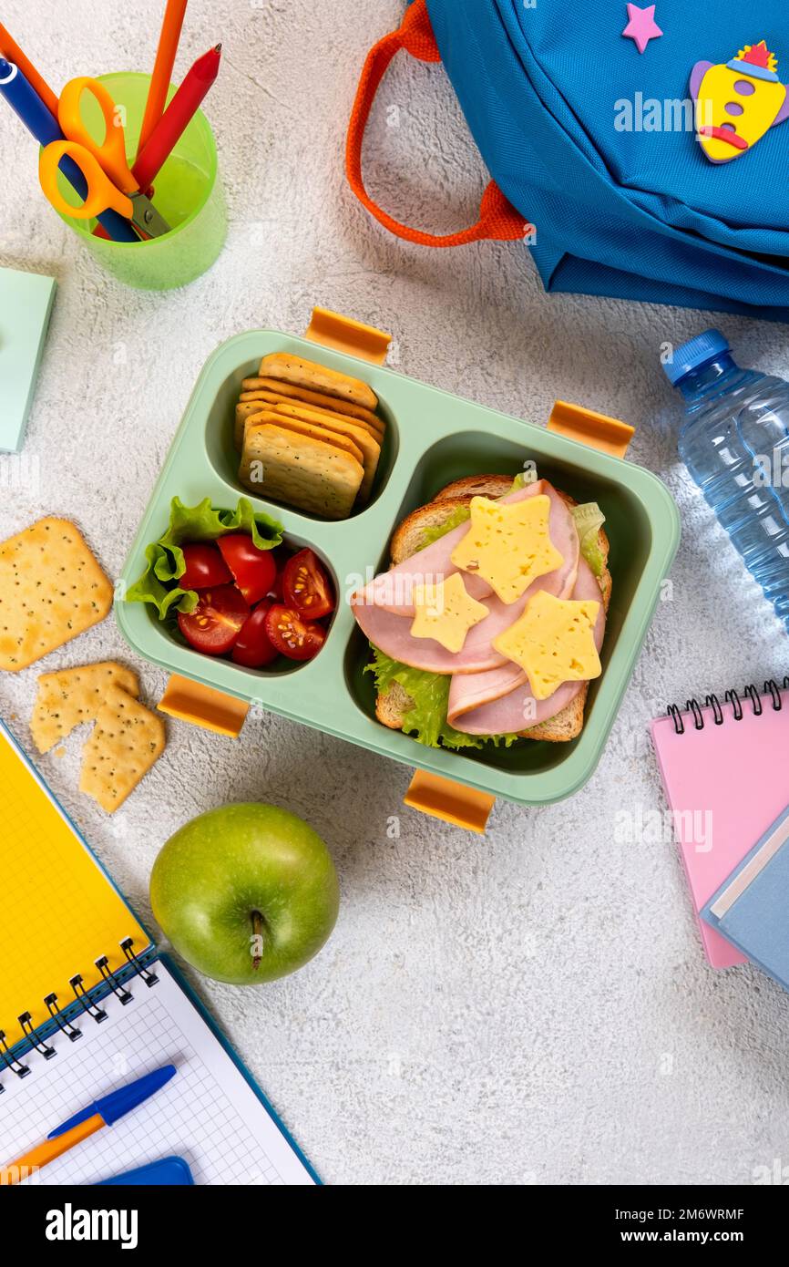 Healthy school lunch box with sandwich and salad on the workplace near ...