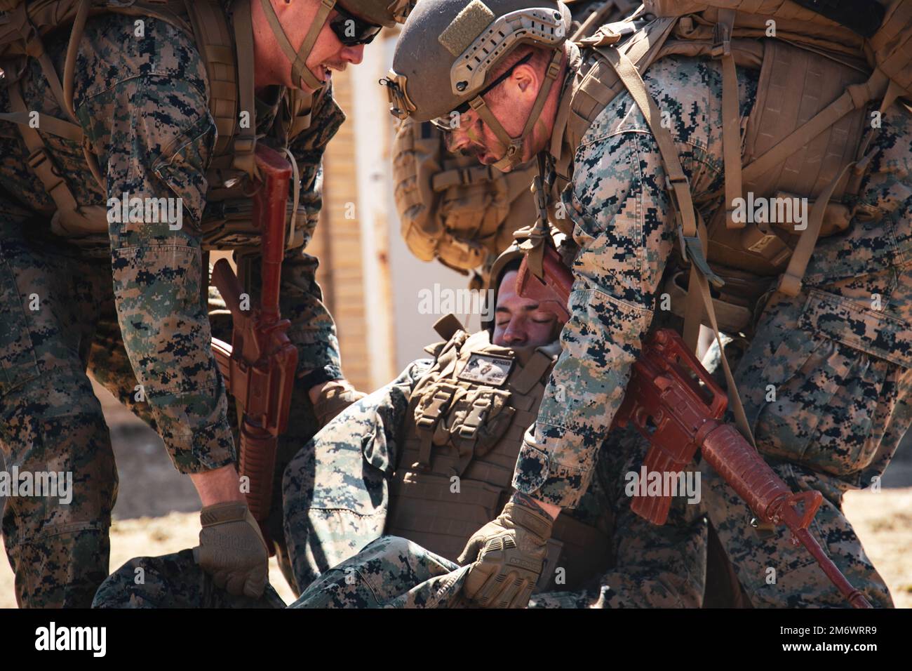 U.S. Navy hospital corpsmen with I Marine Expeditionary Force drag ...