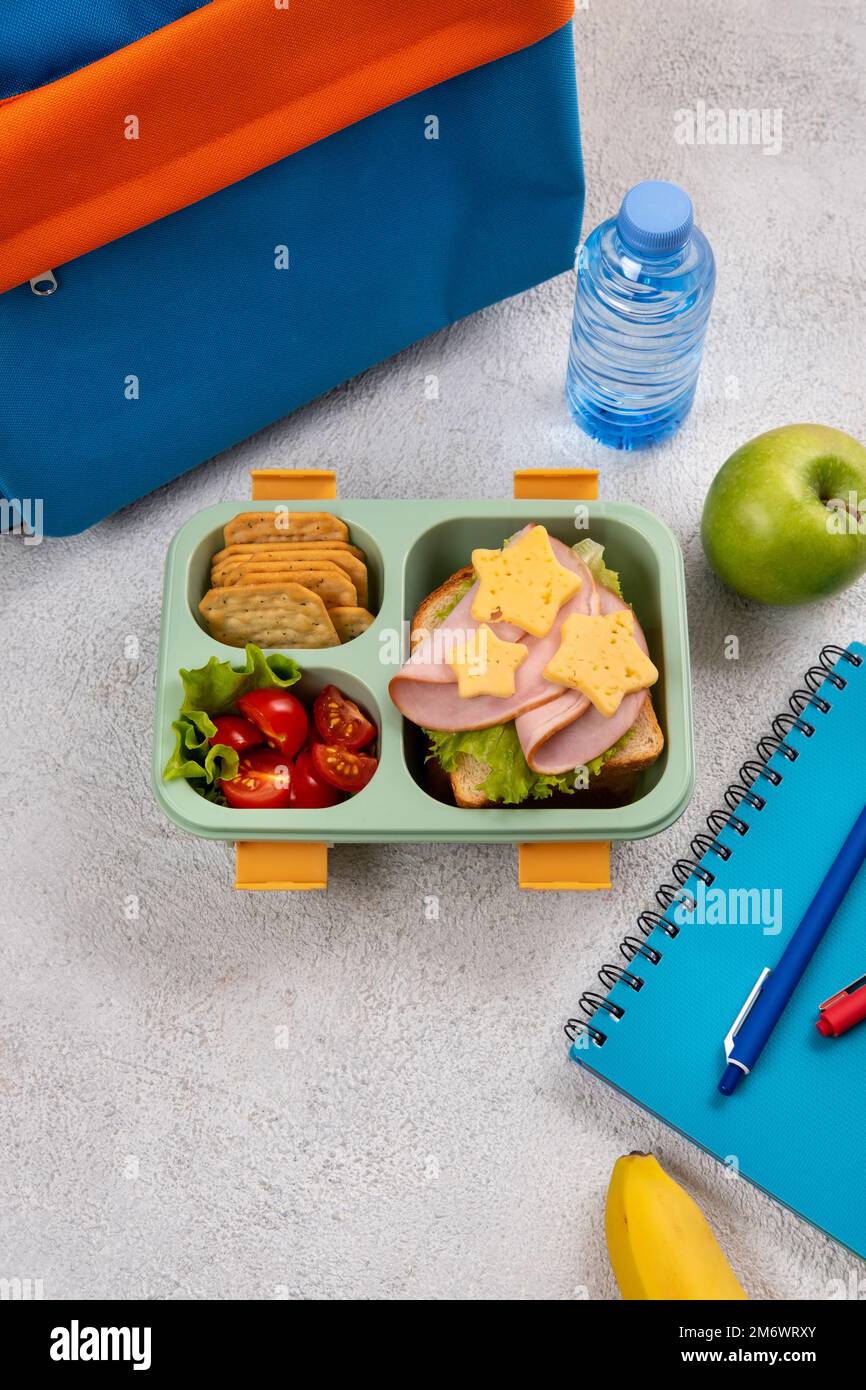 Healthy school lunch box with sandwich and salad on the workplace near ...