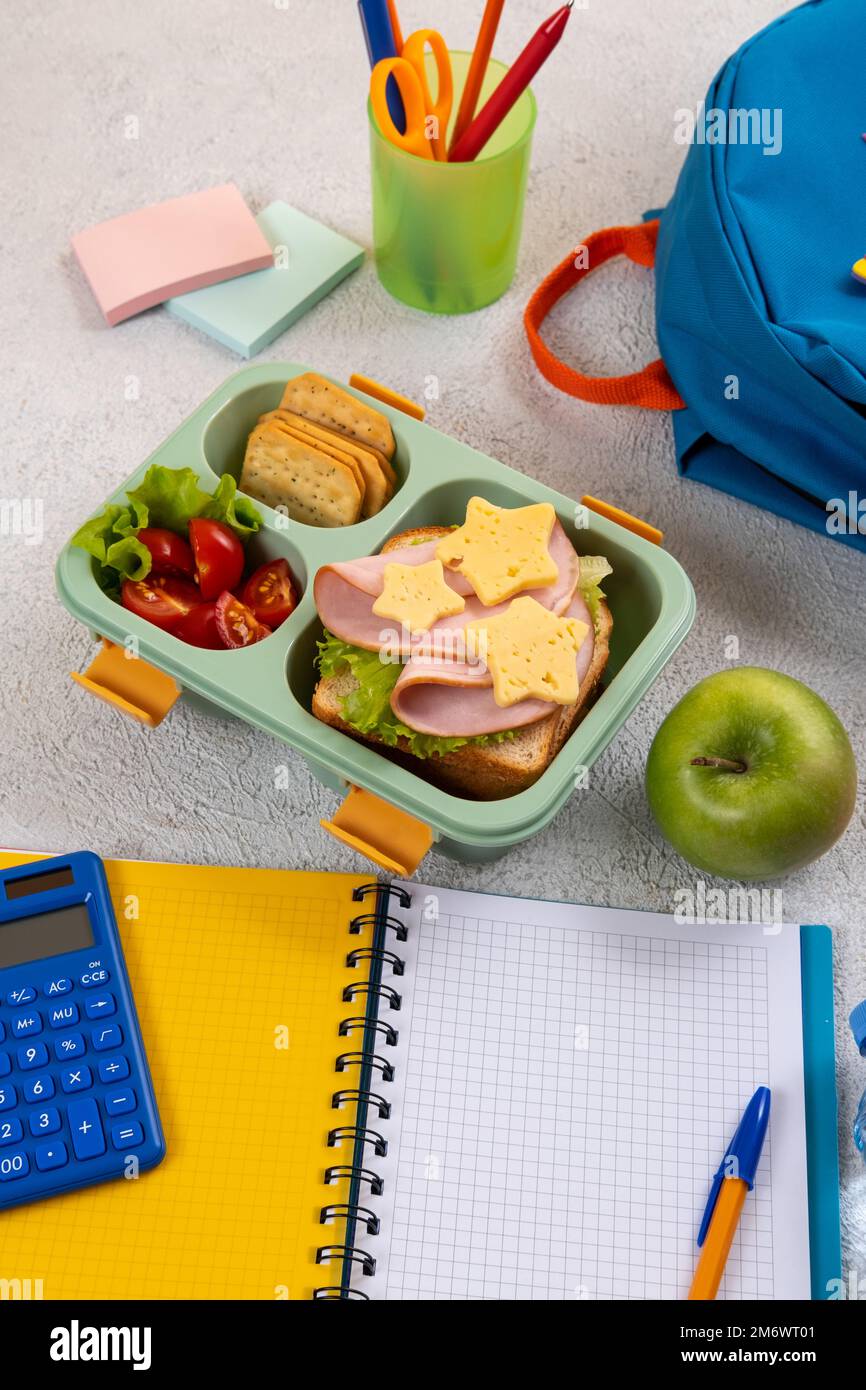 Healthy school lunch box with sandwich and salad on the workplace near ...