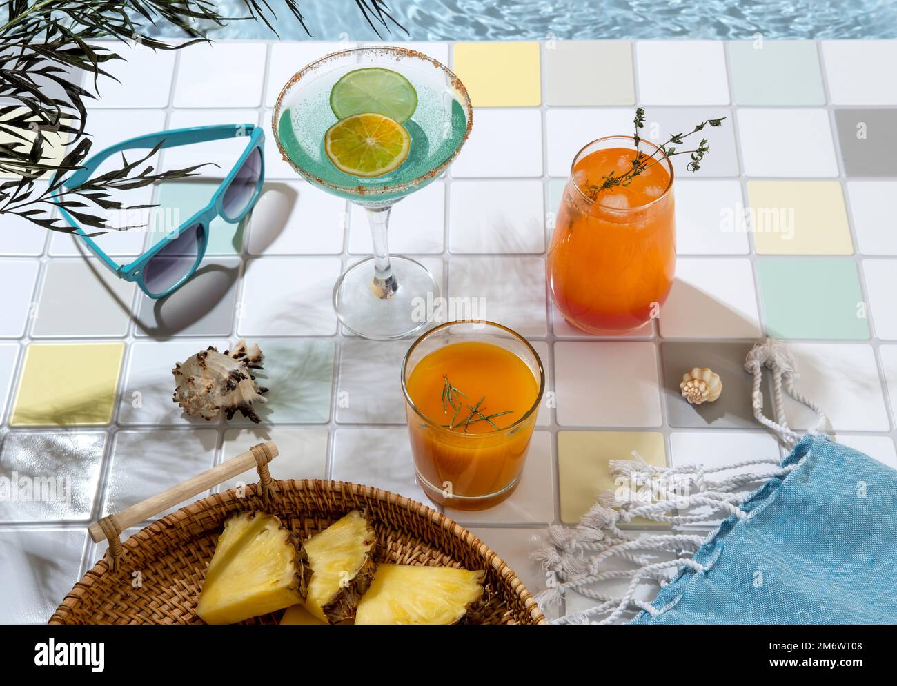 Three Ñ olorful tropical cocktail on edge of swimming pool. Summer ...