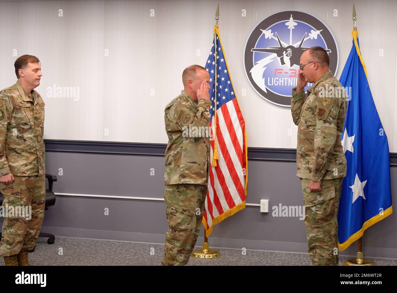 Air Force Col. Ryan Mueller (center), salutes Air Force Lt. Gen. Eric ...