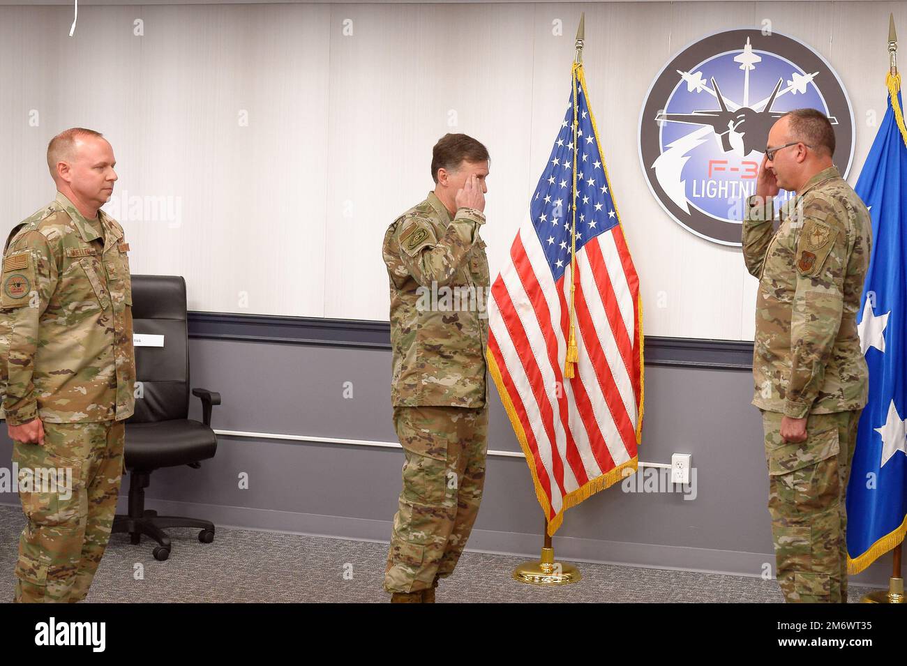 Air Force Col. Robert Lyons (center), salutes Air Force Lt. Gen. Eric ...