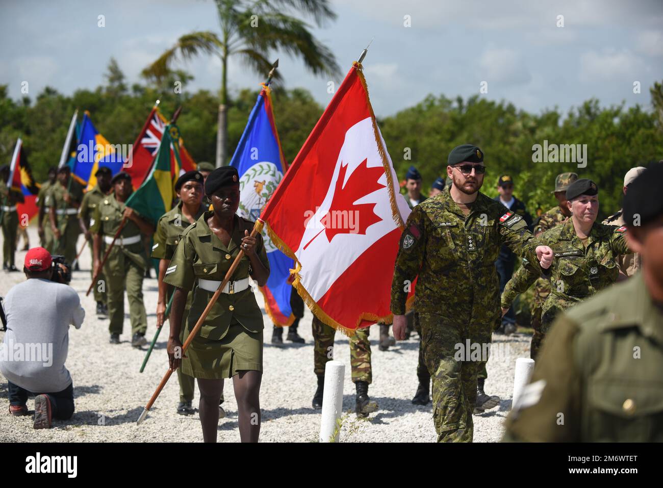 Members from the Belize Defence Force depart the field with the flags ...