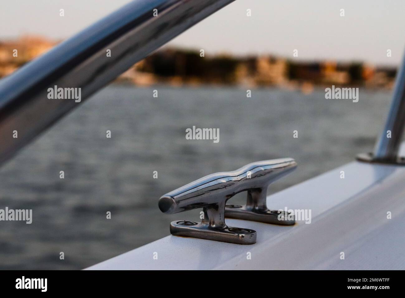 Boat cleat on a boat in the bay with houses in the background Stock ...