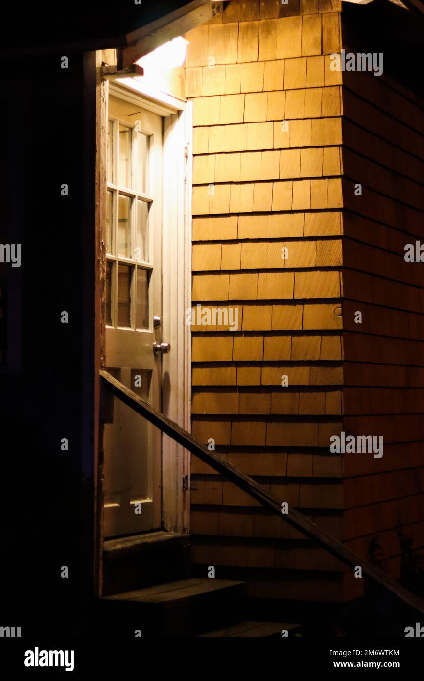 Light over a door on house with wooden siding Stock Photo - Alamy