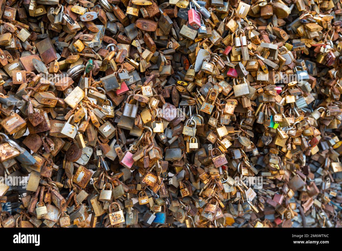 A close-up view of thousands of rusted and colorful love locks full of ...