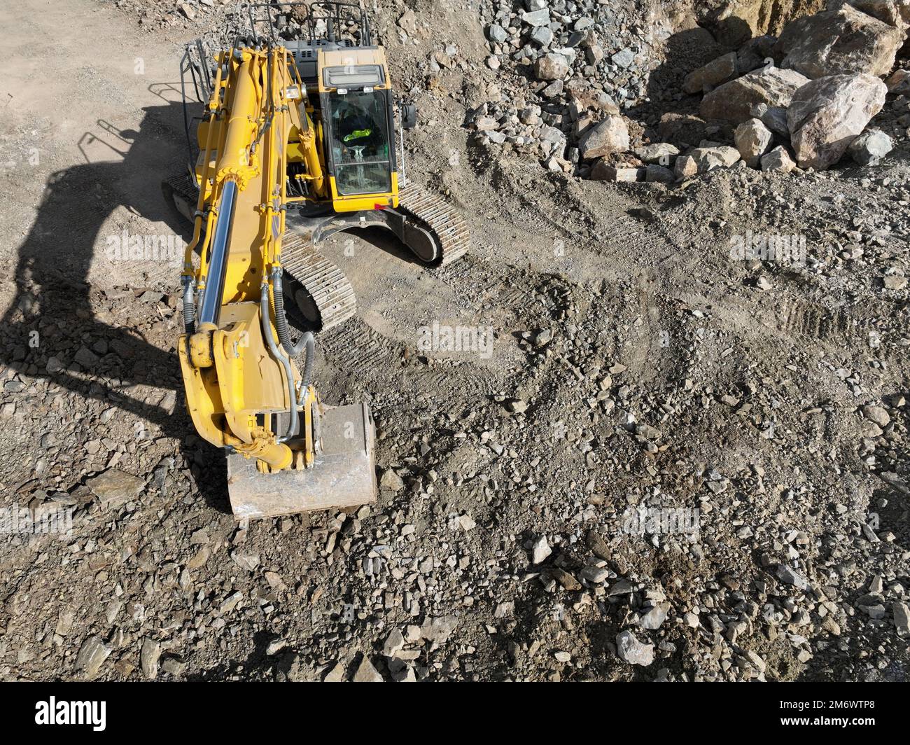 Industrial mine excavators are digging the soil in the construction site and loading trucks ...