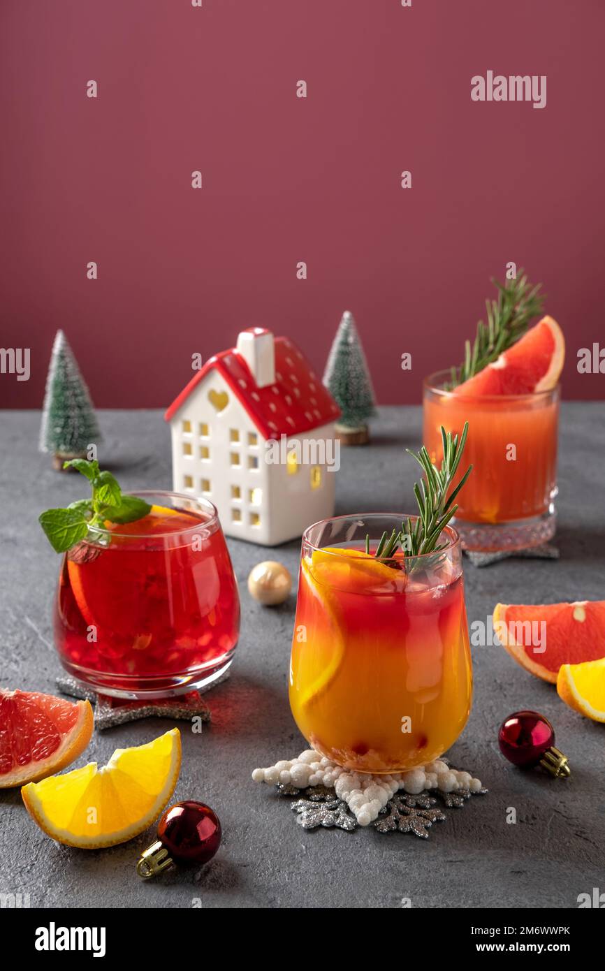 Three festive cocktails with various citrus. Assortment of alcohol ...