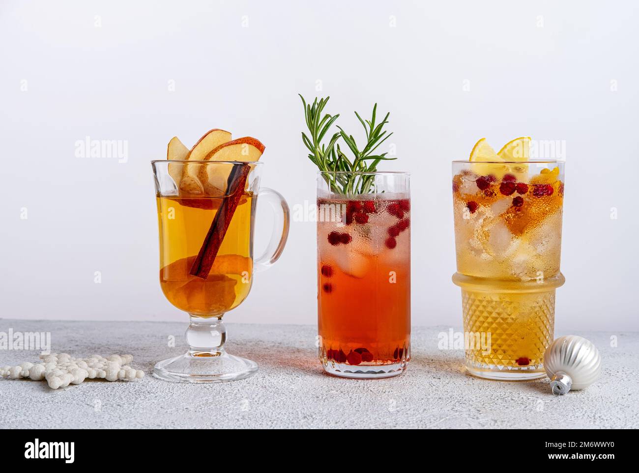 Three colorful Christmas cocktails in glasses on white table ...