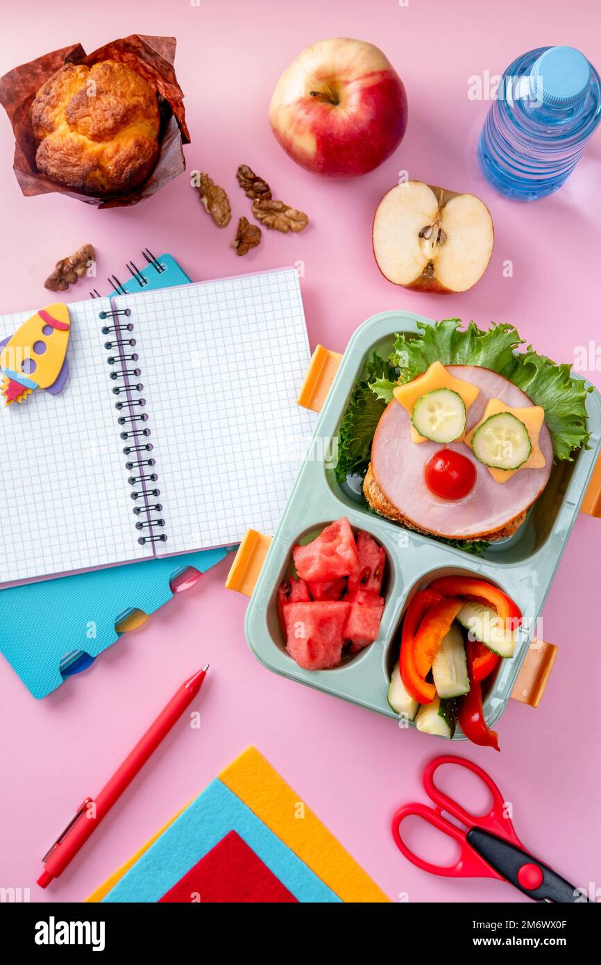 School lunch box for kids with food in the form of funny faces. School ...