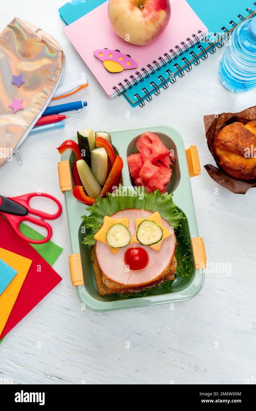 School lunch box for kids with food in the form of funny faces. School ...