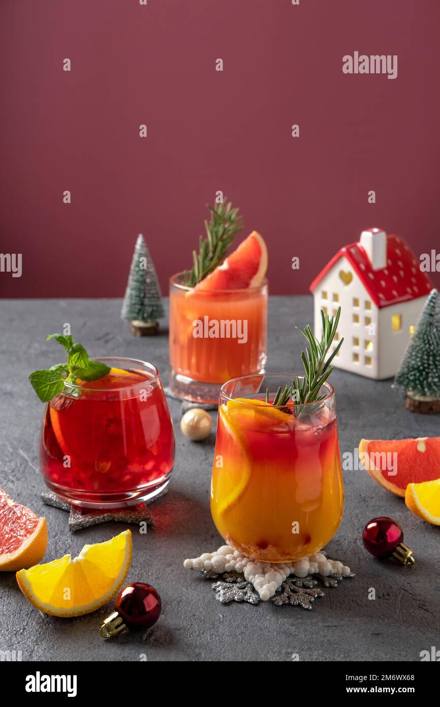 Three festive cocktails with various citrus. Assortment of alcohol ...