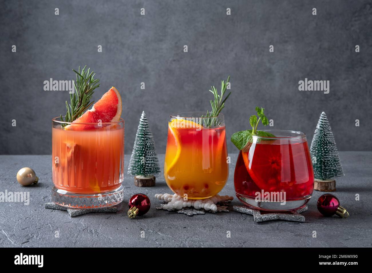 Three festive cocktails with various citrus. Assortment of alcohol ...