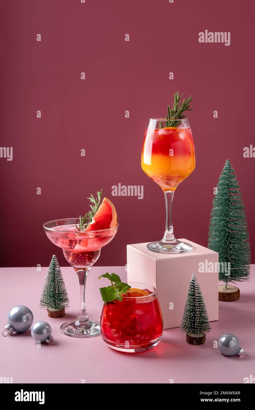 Festive citrus cocktails on podiums. Assortment of fresh Christmas ...