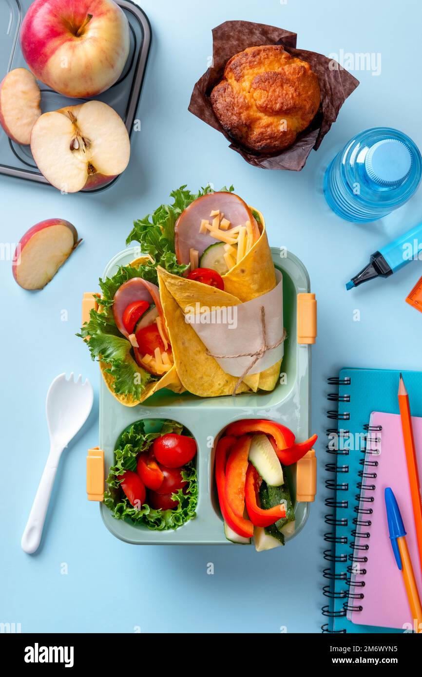 School lunch box for kids with sandwich, vegetables, water and ...