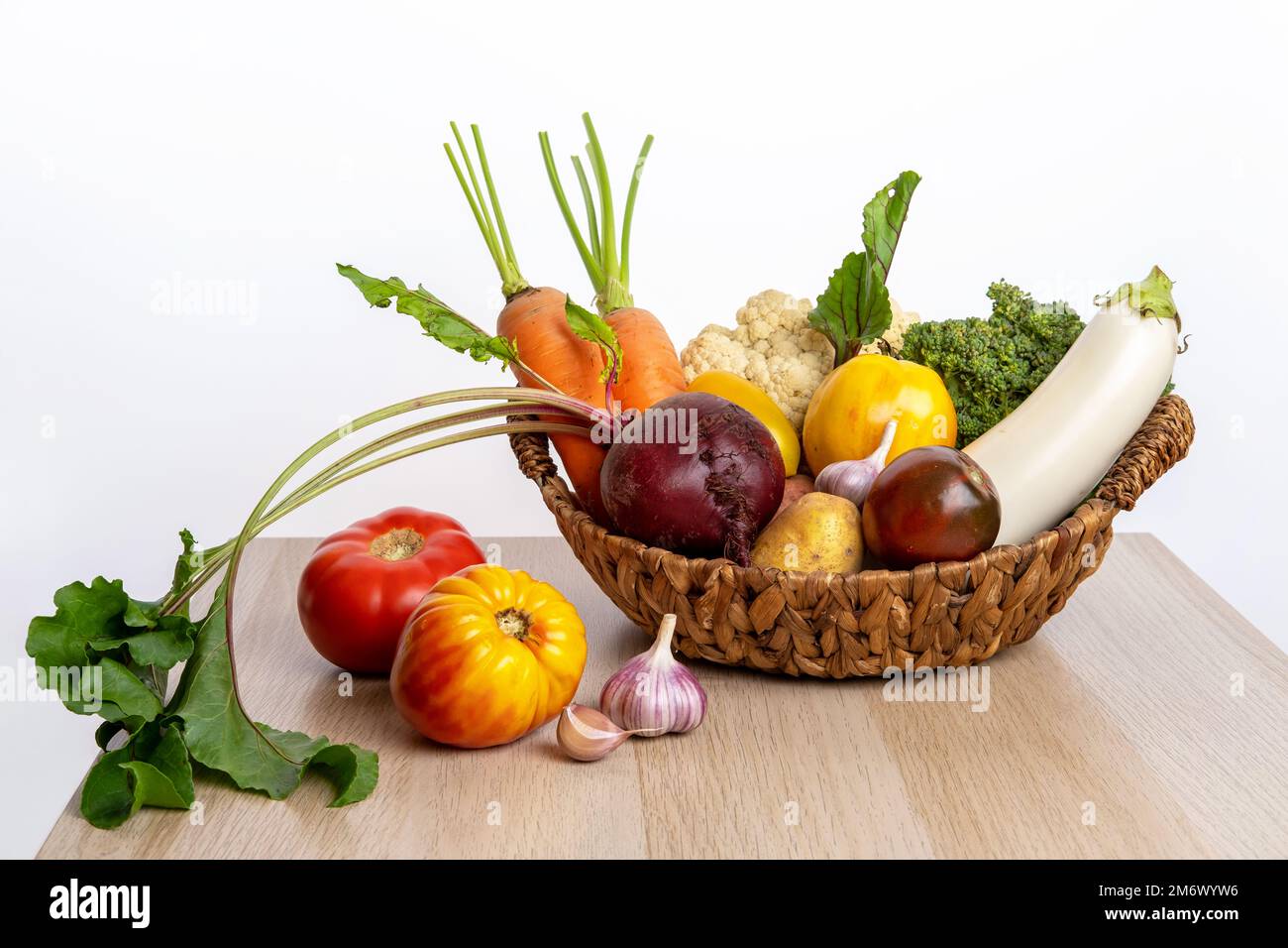 Freshly bunch harvest. Fresh farm vegetables in wicker basket. Healthy ...