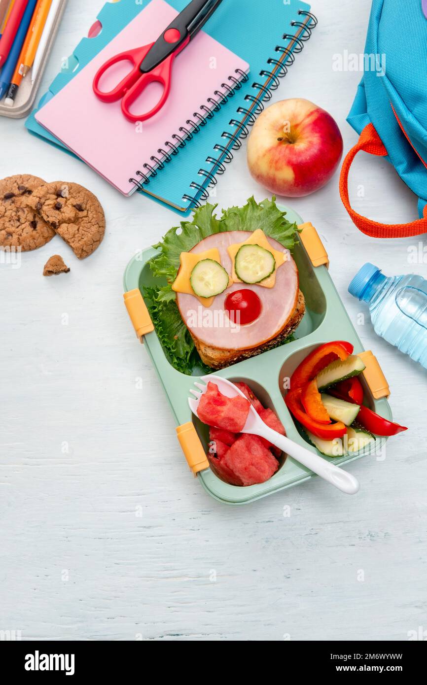 School lunch box for kids with food in the form of funny faces. School ...
