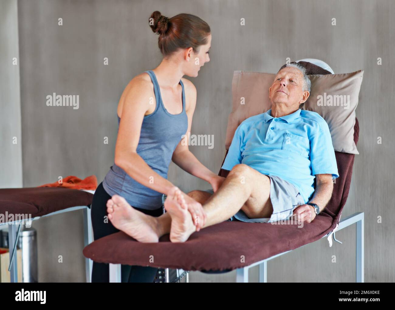 Helping her patients stay strong and healthy. a senior man at a ...