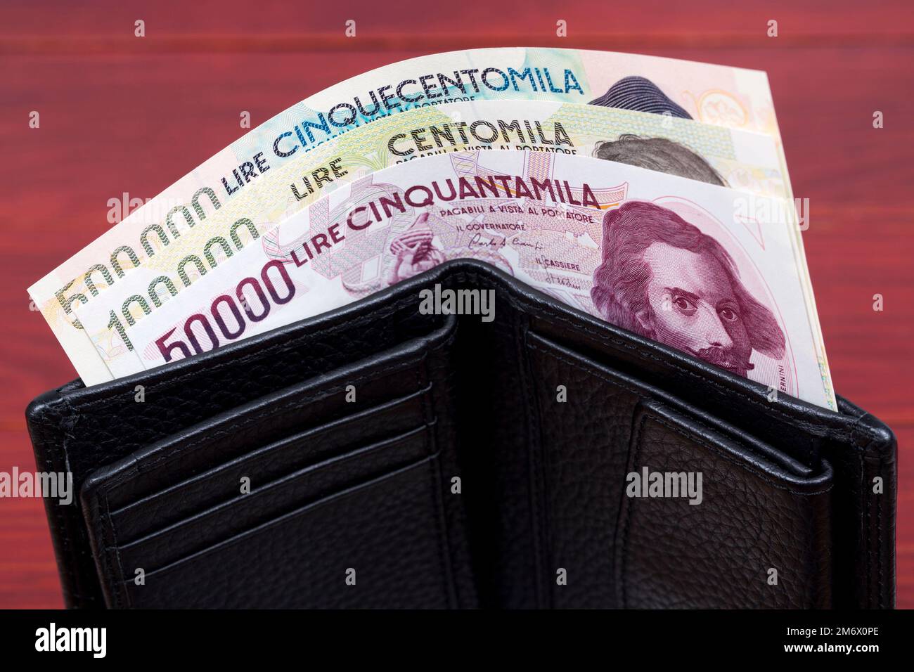 Italian money - lira in the black wallet Stock Photo - Alamy