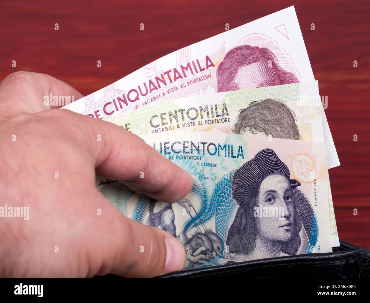Italian money - lira in the black wallet Stock Photo - Alamy