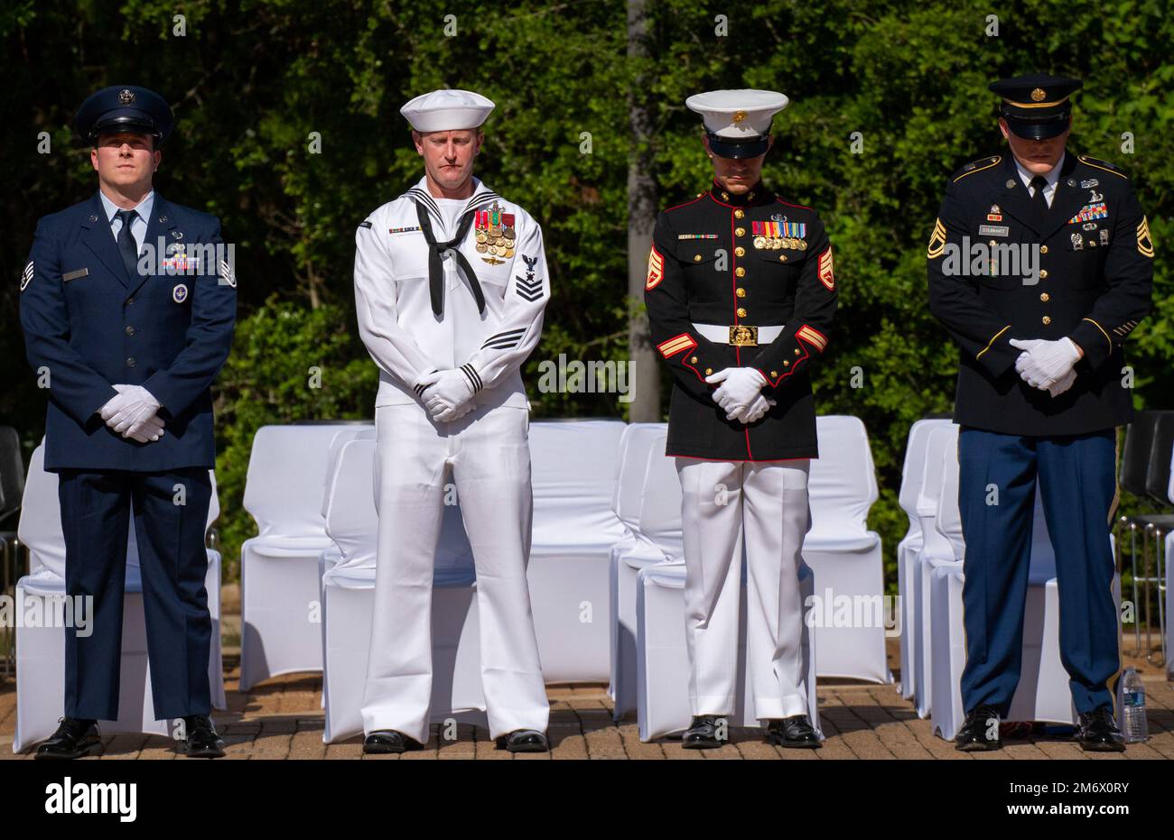 Military members from all four services stand together during the ...