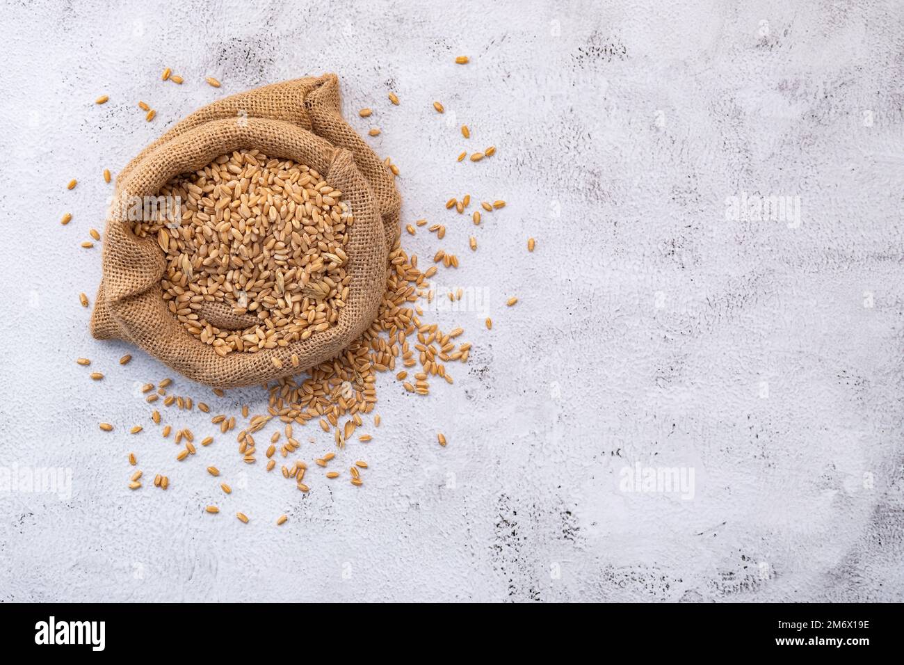 Wheat ears and wheat grains set up on white stone background Stock ...